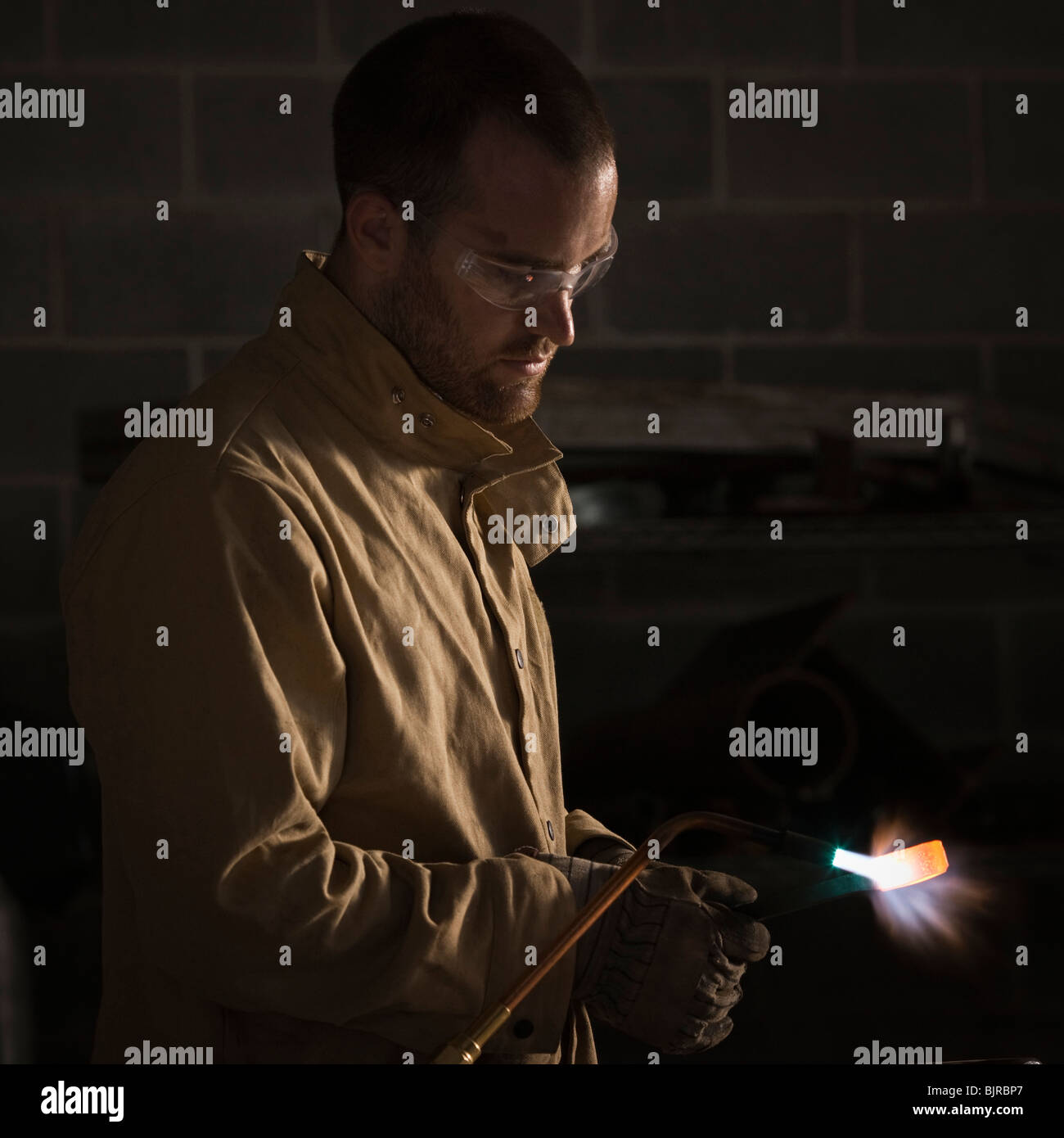 USA, Utah, Orem, male welder using blowtorch in workshop Stock Photo ...