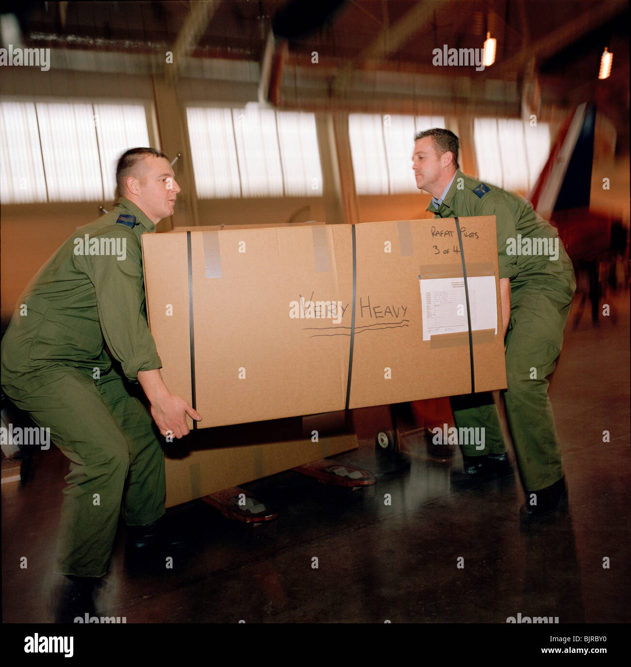 Red Arrows support personnel (Called The Blues) manhandle heavy tri ...