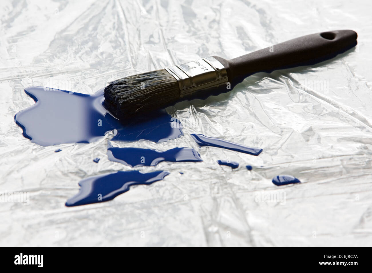 Paintbrush and blue paint Stock Photo - Alamy