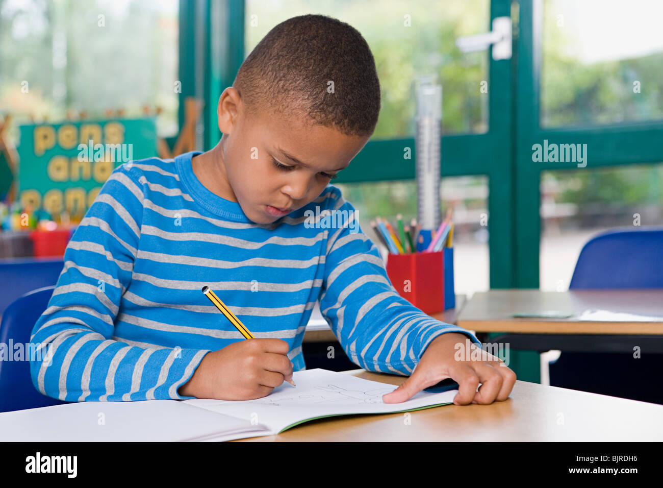African boy writing hi-res stock photography and images - Alamy