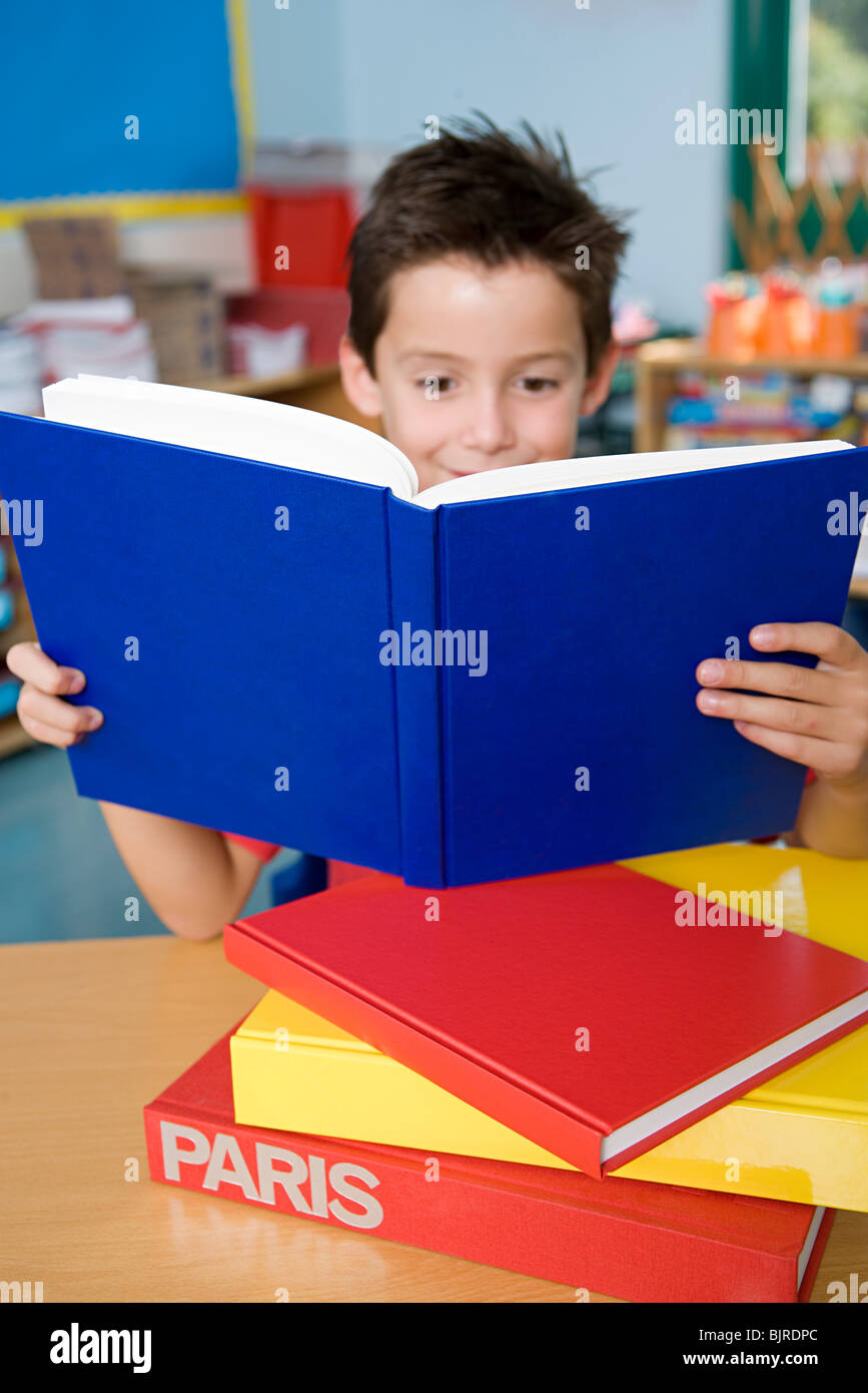 Boy reading a book Stock Photo - Alamy