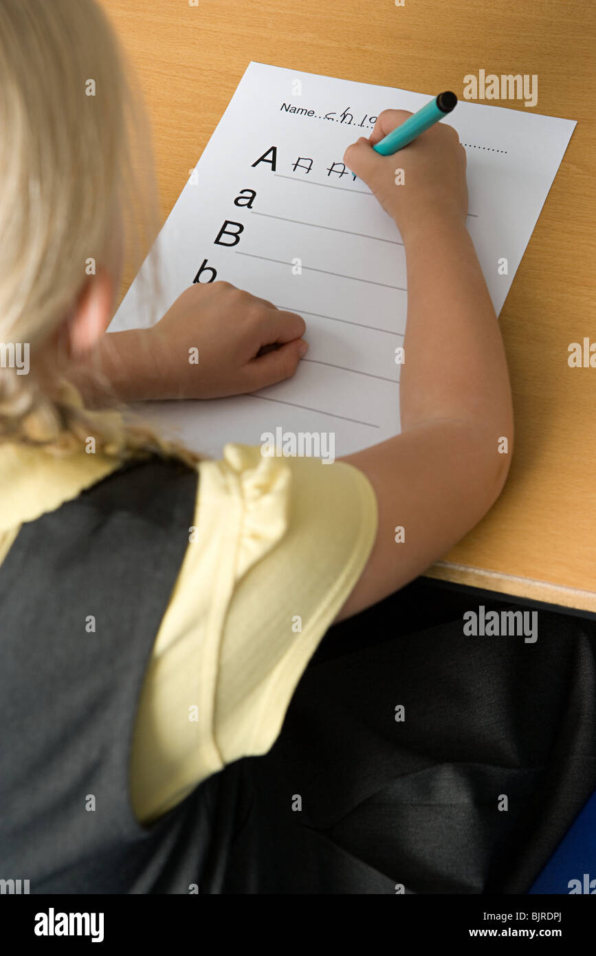 Girl writing alphabet Stock Photo - Alamy
