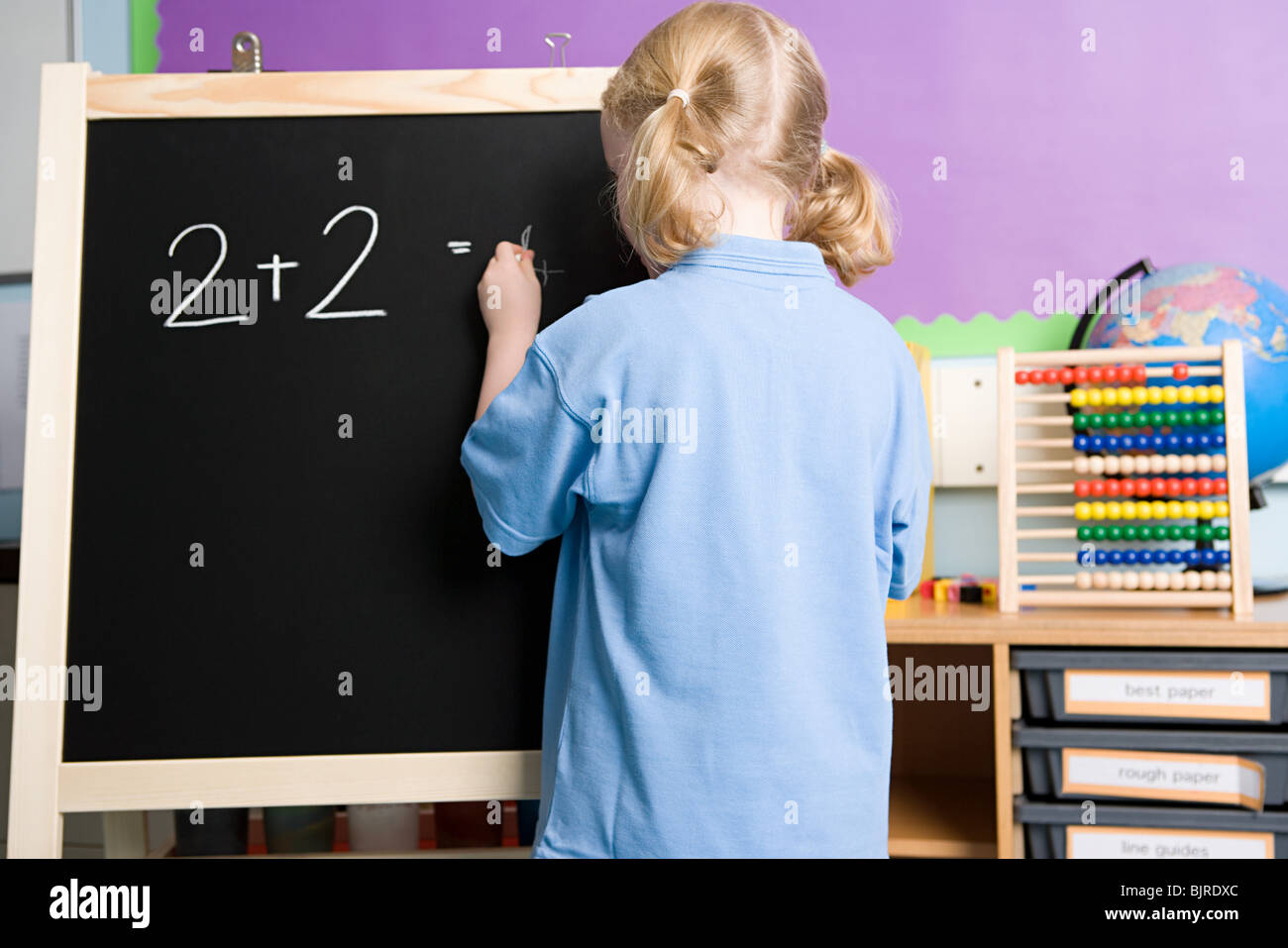 Girl solving sums Stock Photo - Alamy