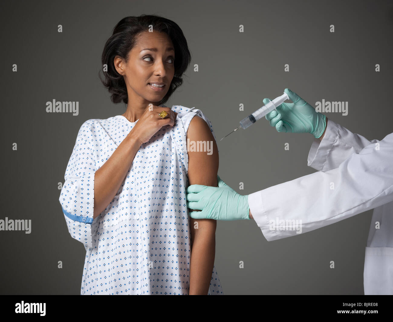 Mid adult woman receiving injection Stock Photo - Alamy