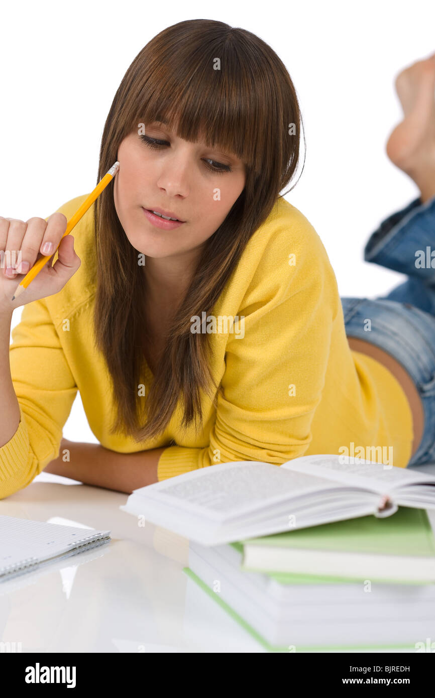 Student - female teenager write homework with book on white background ...