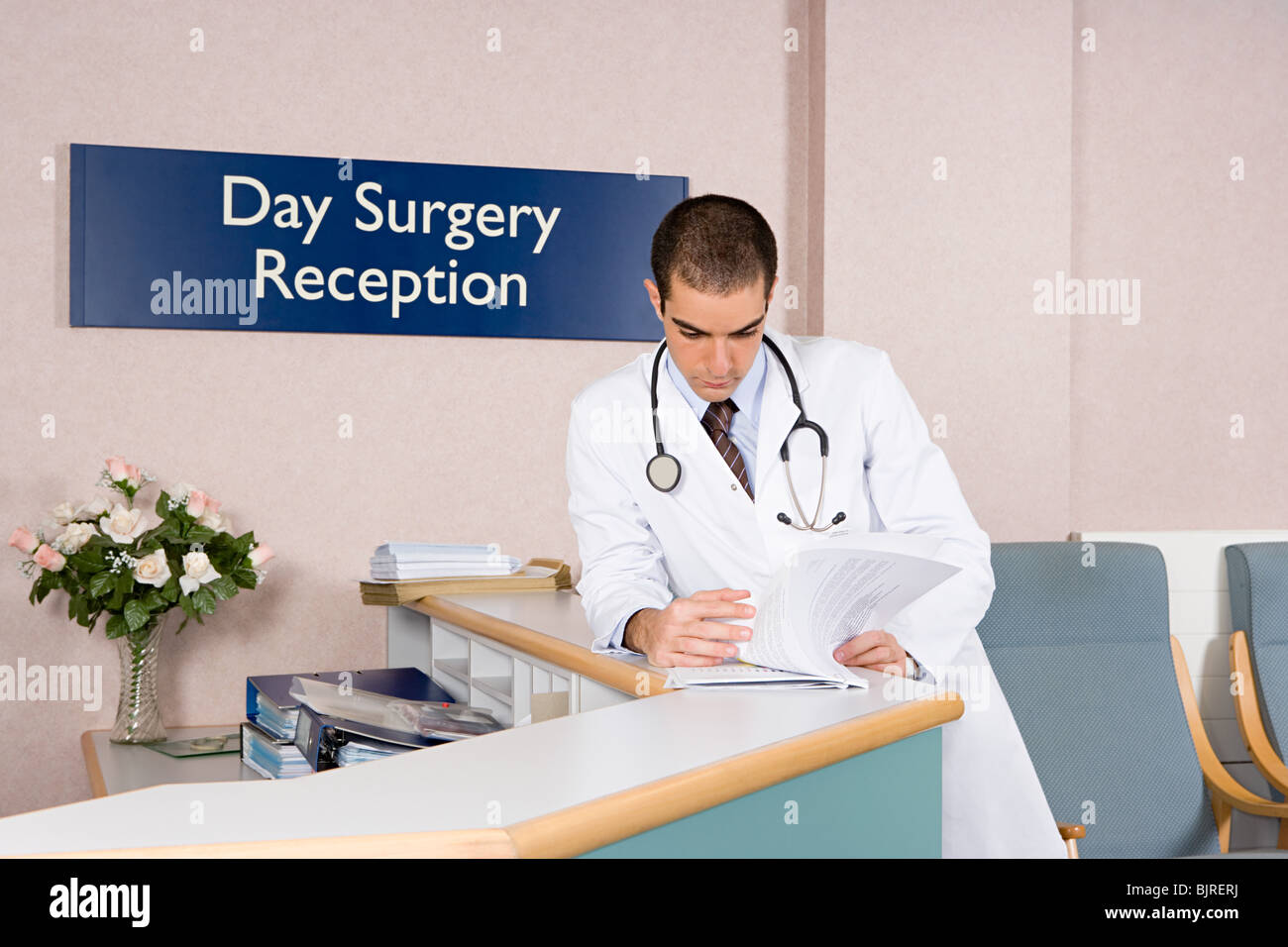 Doctor looking at paperwork Stock Photo - Alamy