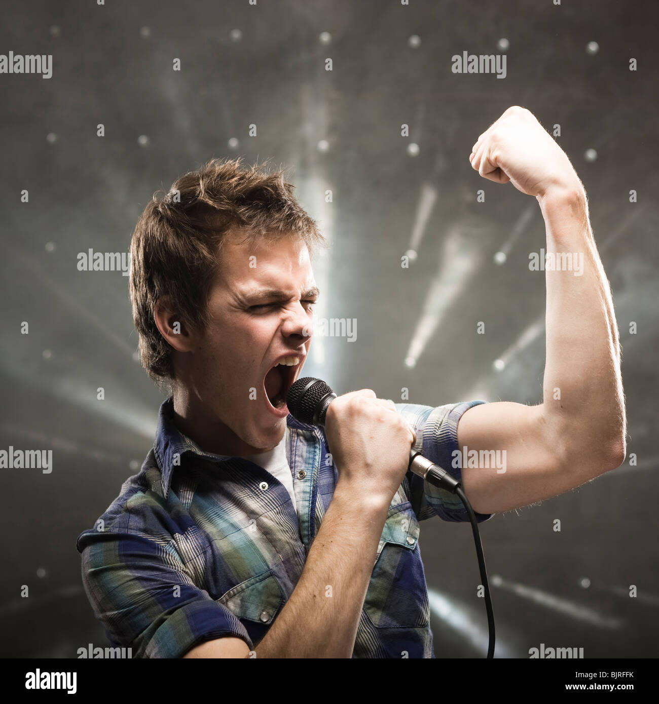 Young man singing, studio shot Stock Photo - Alamy