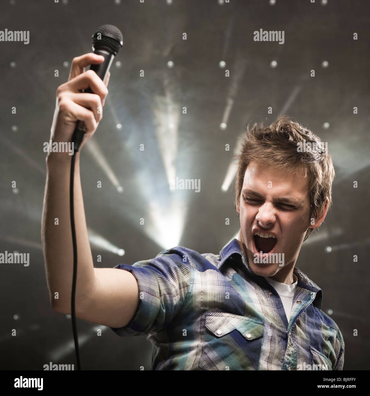 Young man singing, studio shot Stock Photo - Alamy