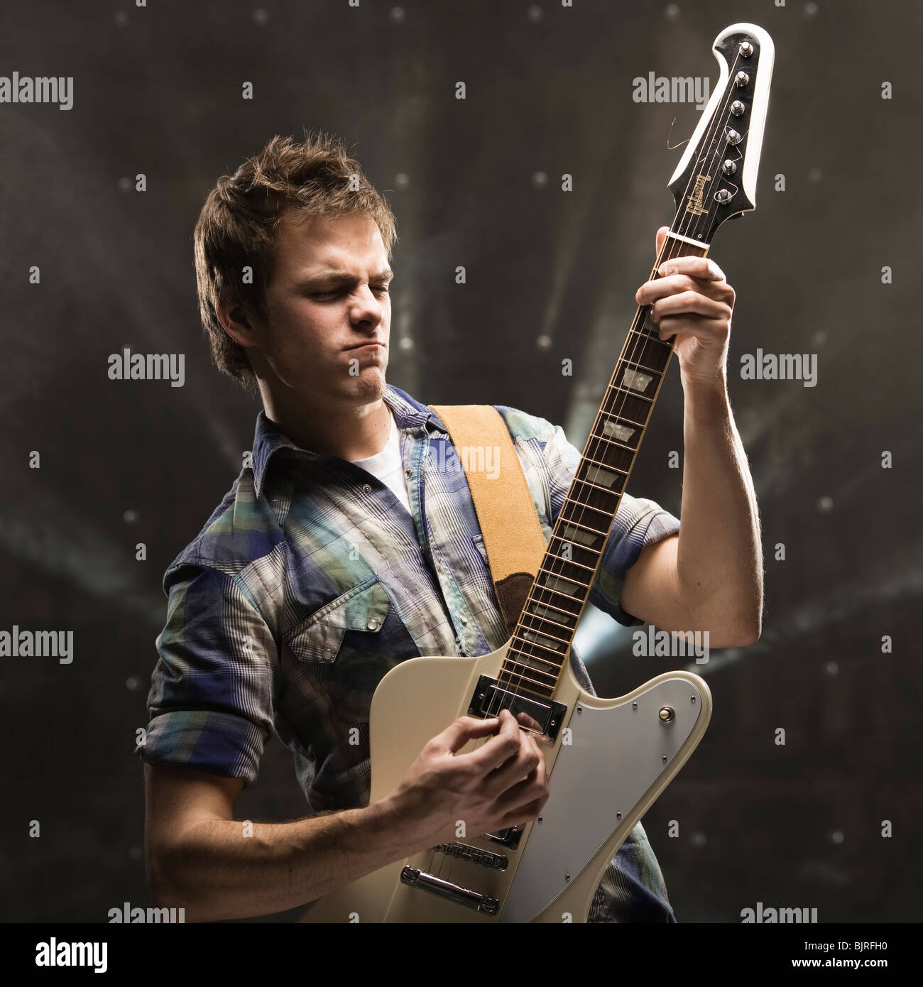 Young man playing bass guitar, studio shot Stock Photo - Alamy