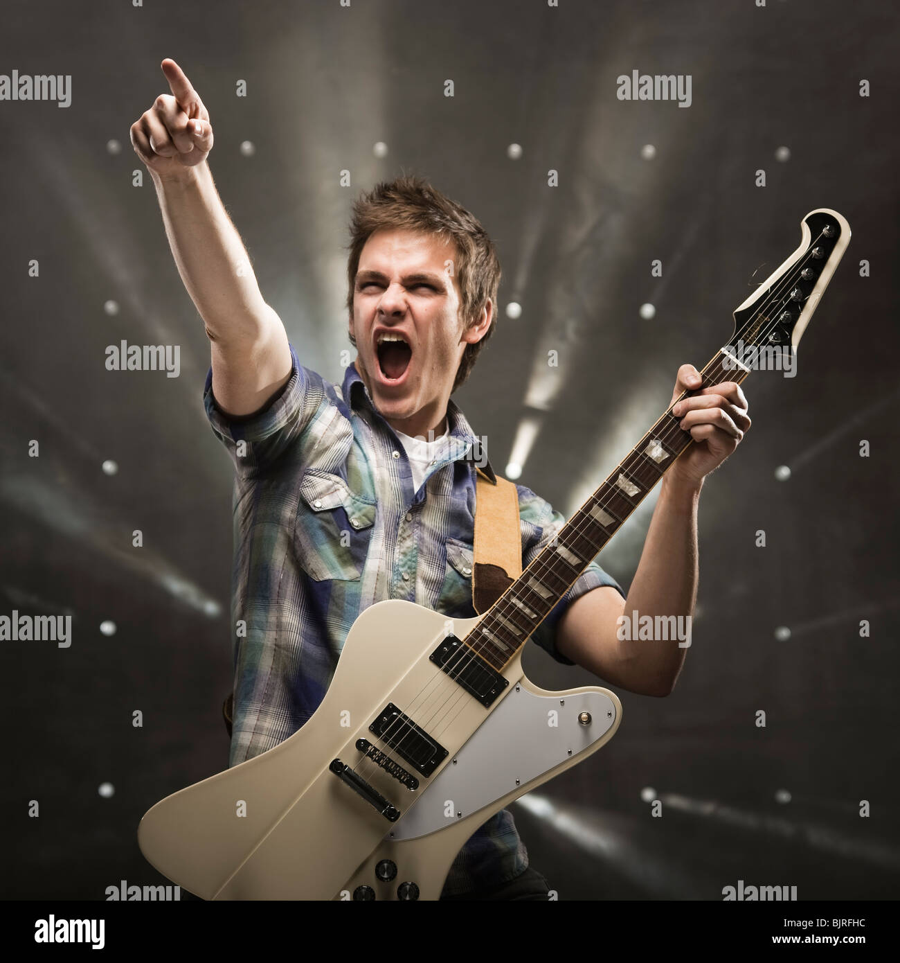 Young man playing bass guitar, studio shot Stock Photo - Alamy