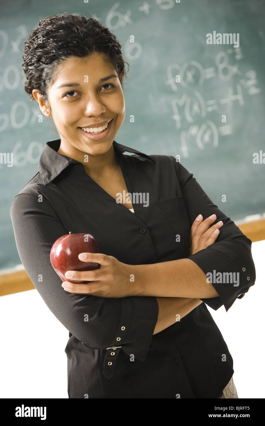 Female teacher standing in front of a blackboard Stock Photo - Alamy