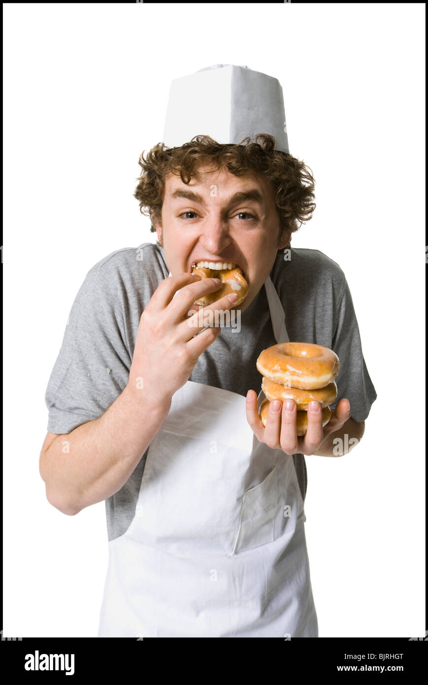 Cook eating donuts Stock Photo - Alamy