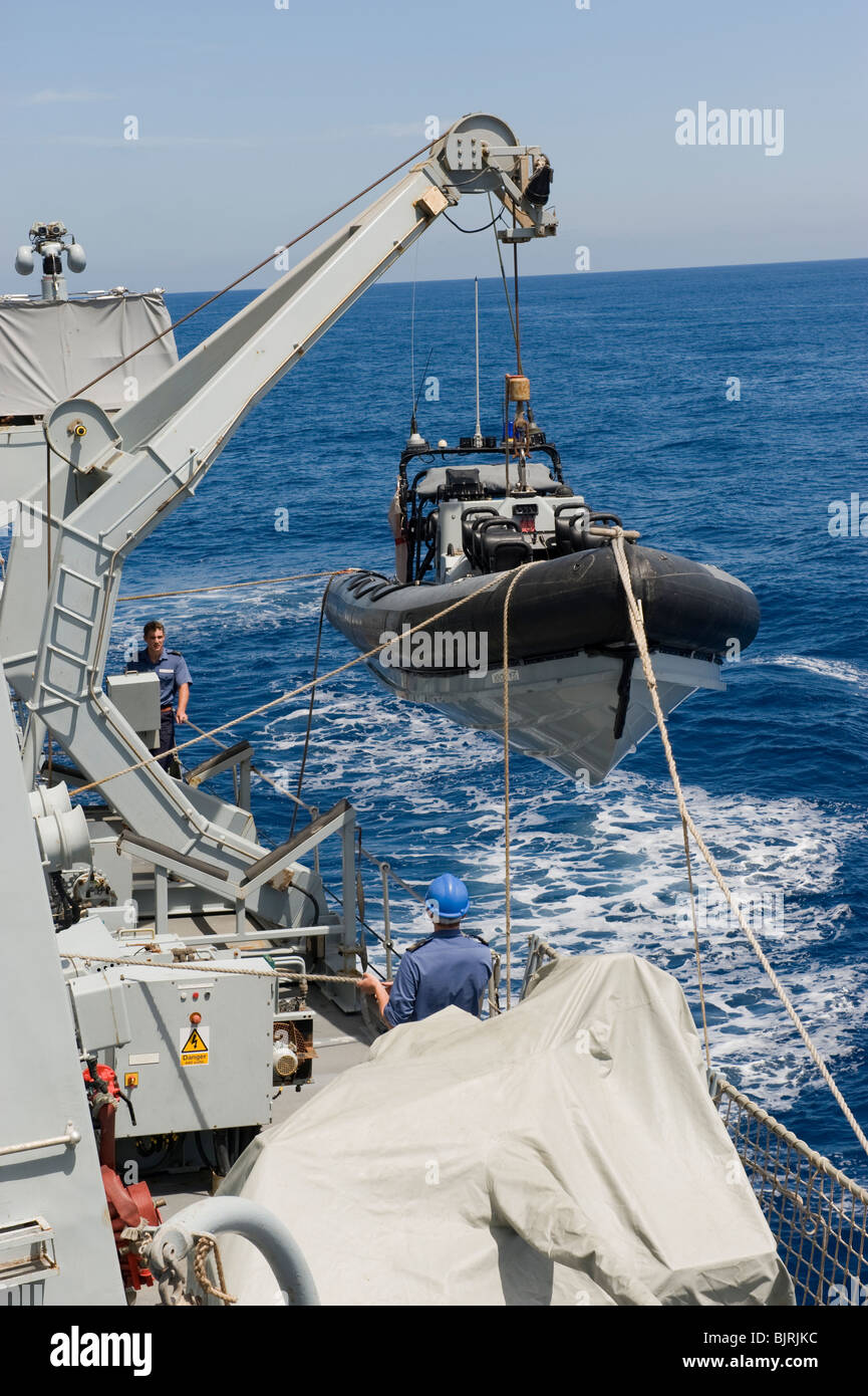 Royal Navy RIB seaboat being deployed from Type 23 frigate at sea Stock ...