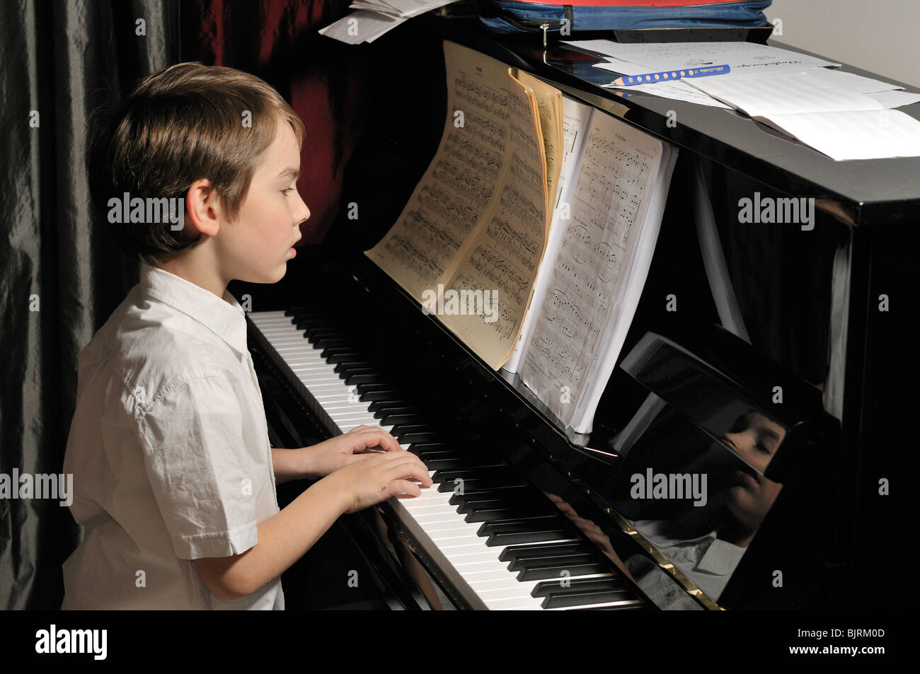 Schoolboy plays the piano Stock Photo - Alamy