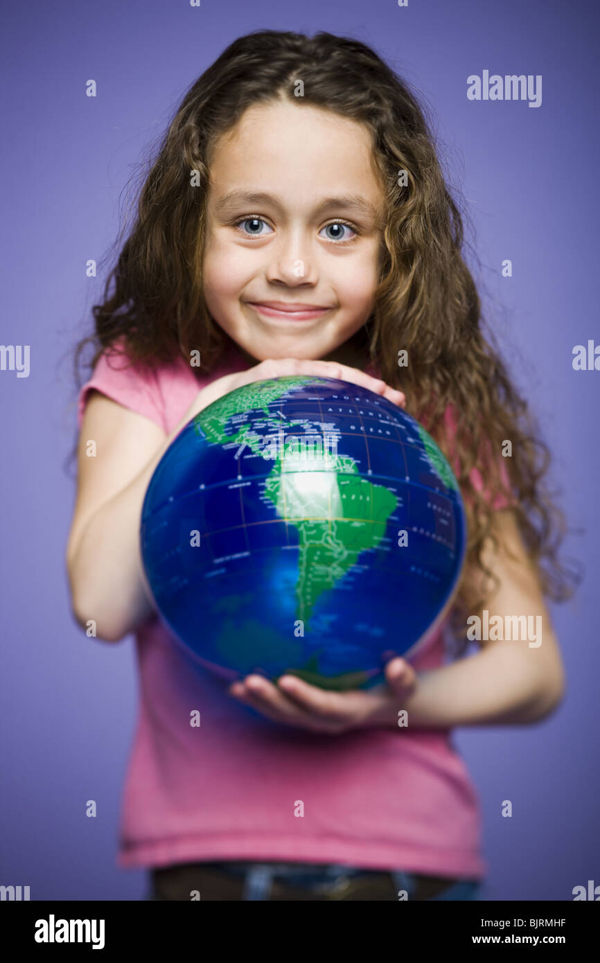 Young girl holding earth globe Stock Photo - Alamy