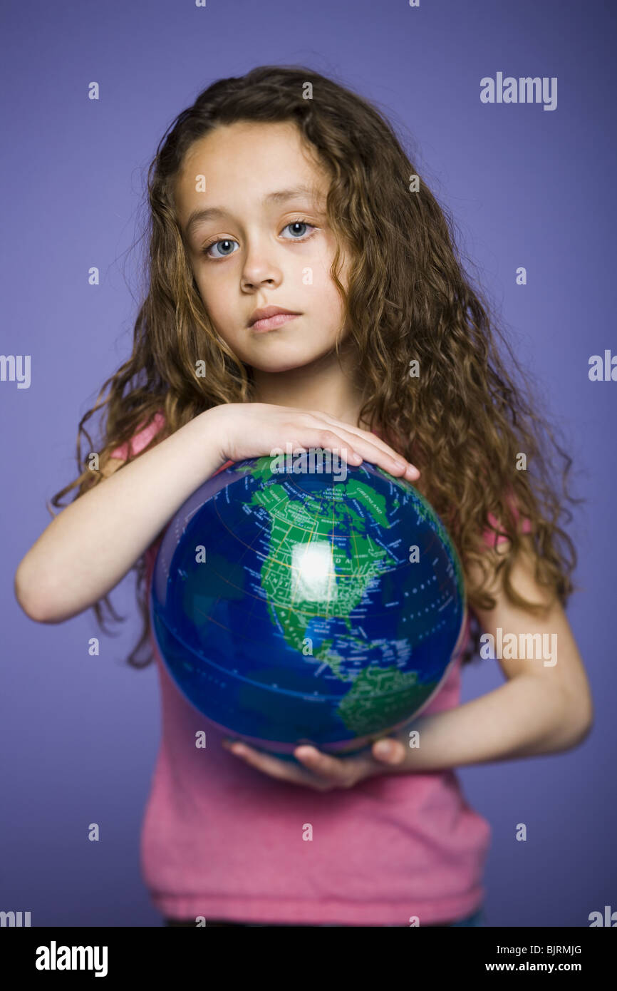 Young girl holding earth globe Stock Photo - Alamy