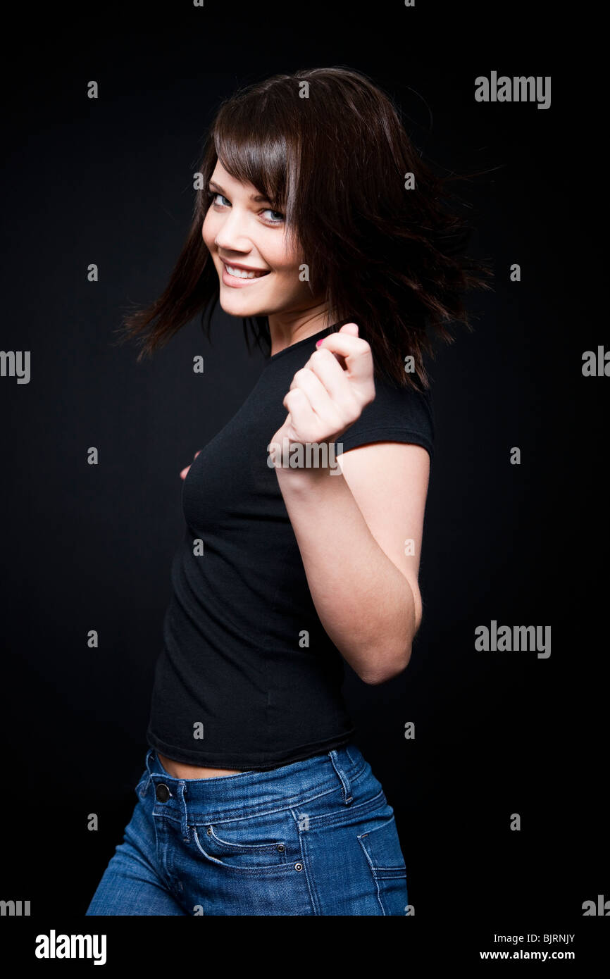 Studio portrait of young woman dancing Stock Photo - Alamy