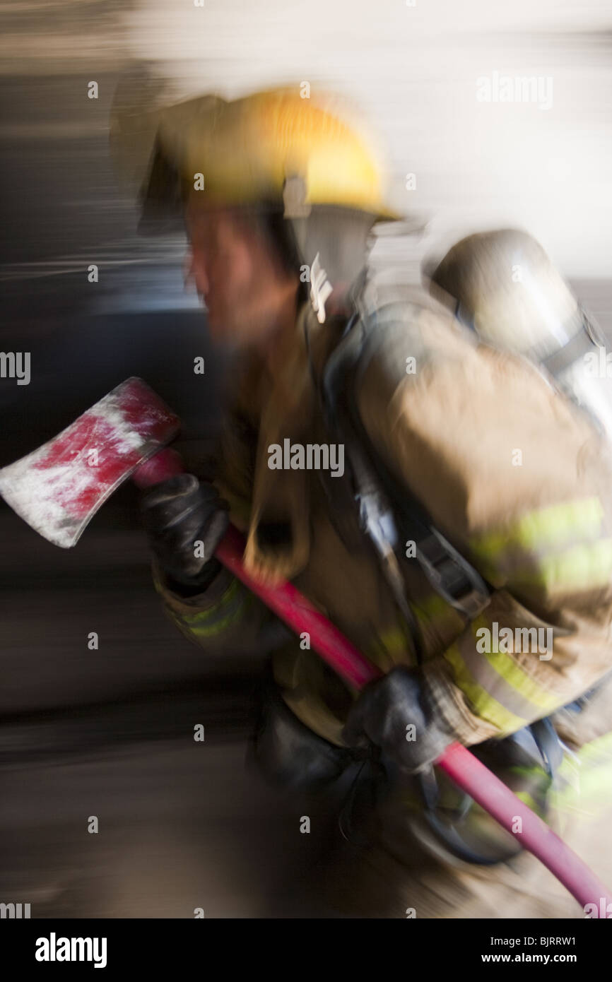 Male firefighter in action Stock Photo - Alamy