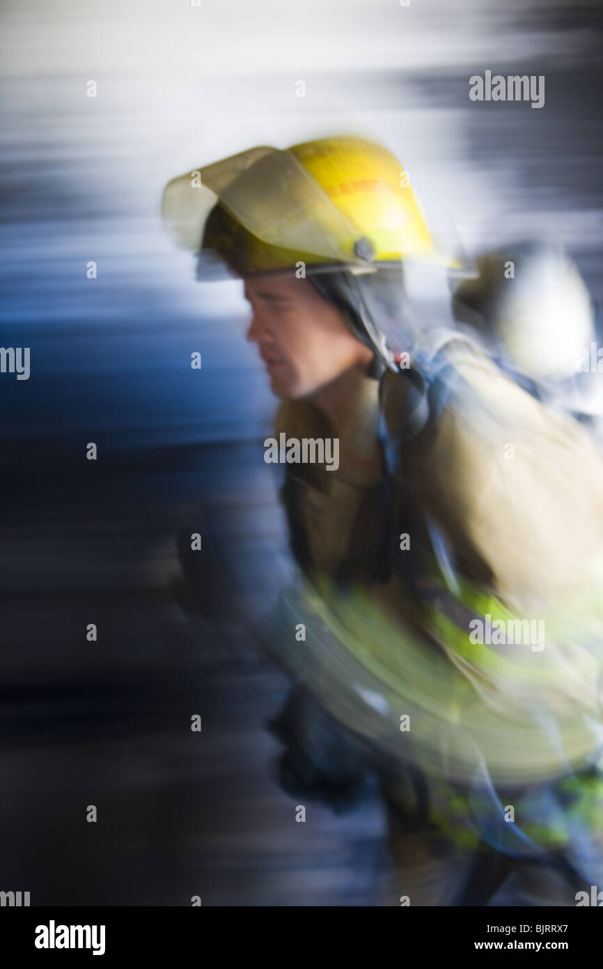Male firefighter in action Stock Photo - Alamy