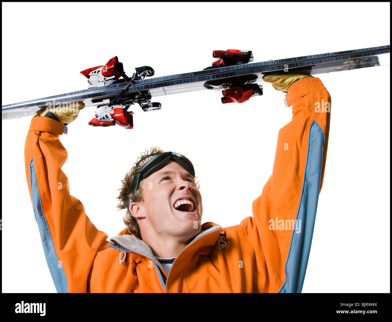 Male skier in orange ski jacket Stock Photo - Alamy