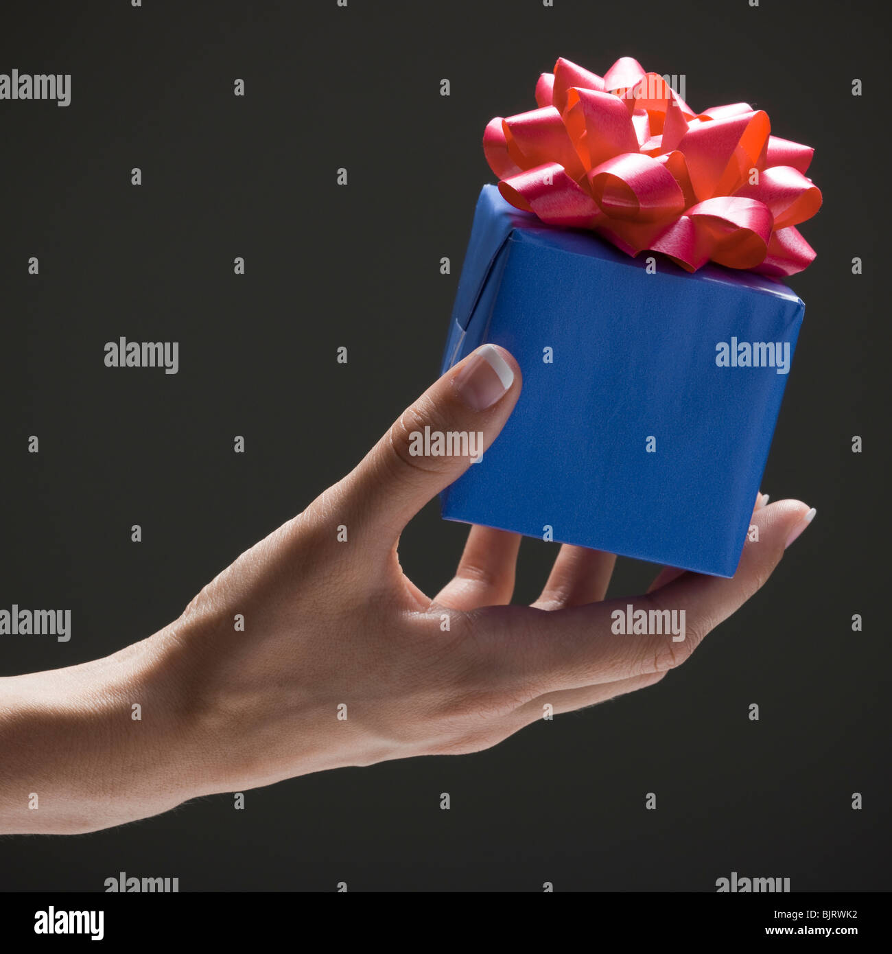 Hand holding a gift Stock Photo - Alamy