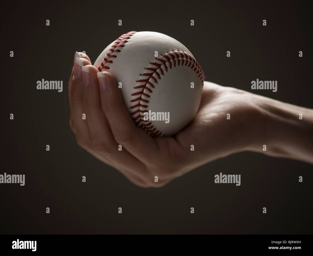 Hand holding a baseball Stock Photo - Alamy