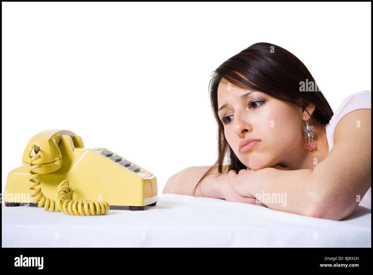 Woman waiting for a call on the telephone Stock Photo - Alamy