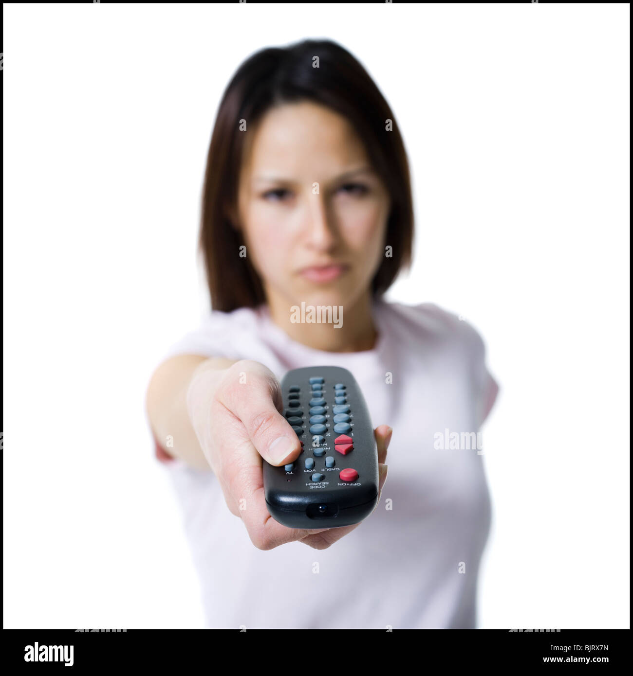 Woman pointing and pressing a handheld remote control Stock Photo - Alamy