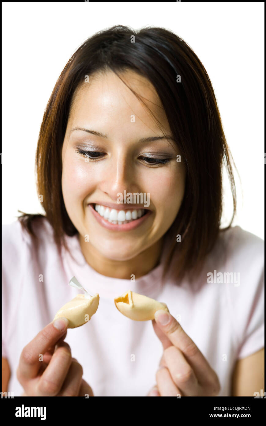 Woman opening a fortune cookie Stock Photo - Alamy