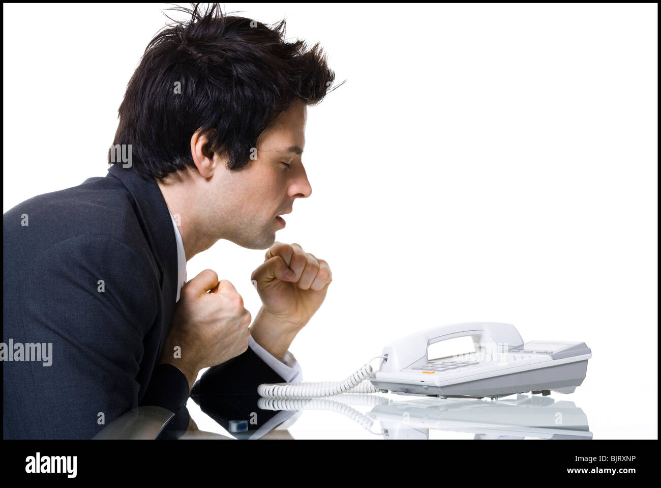 Businessman waiting anxiously for telephone call Stock Photo - Alamy