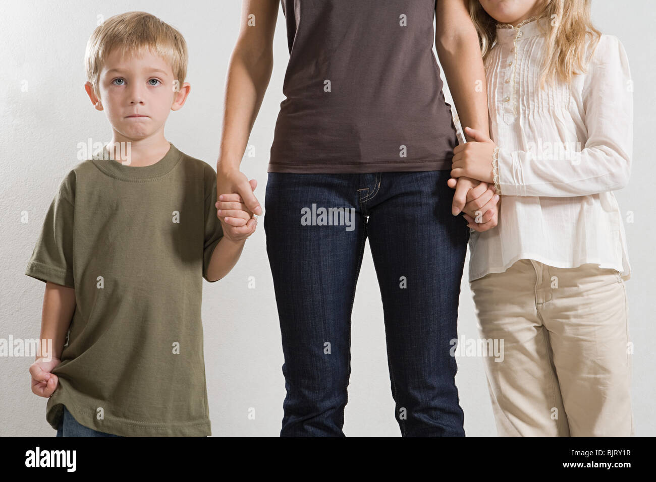 Children holding their mothers hand Stock Photo - Alamy