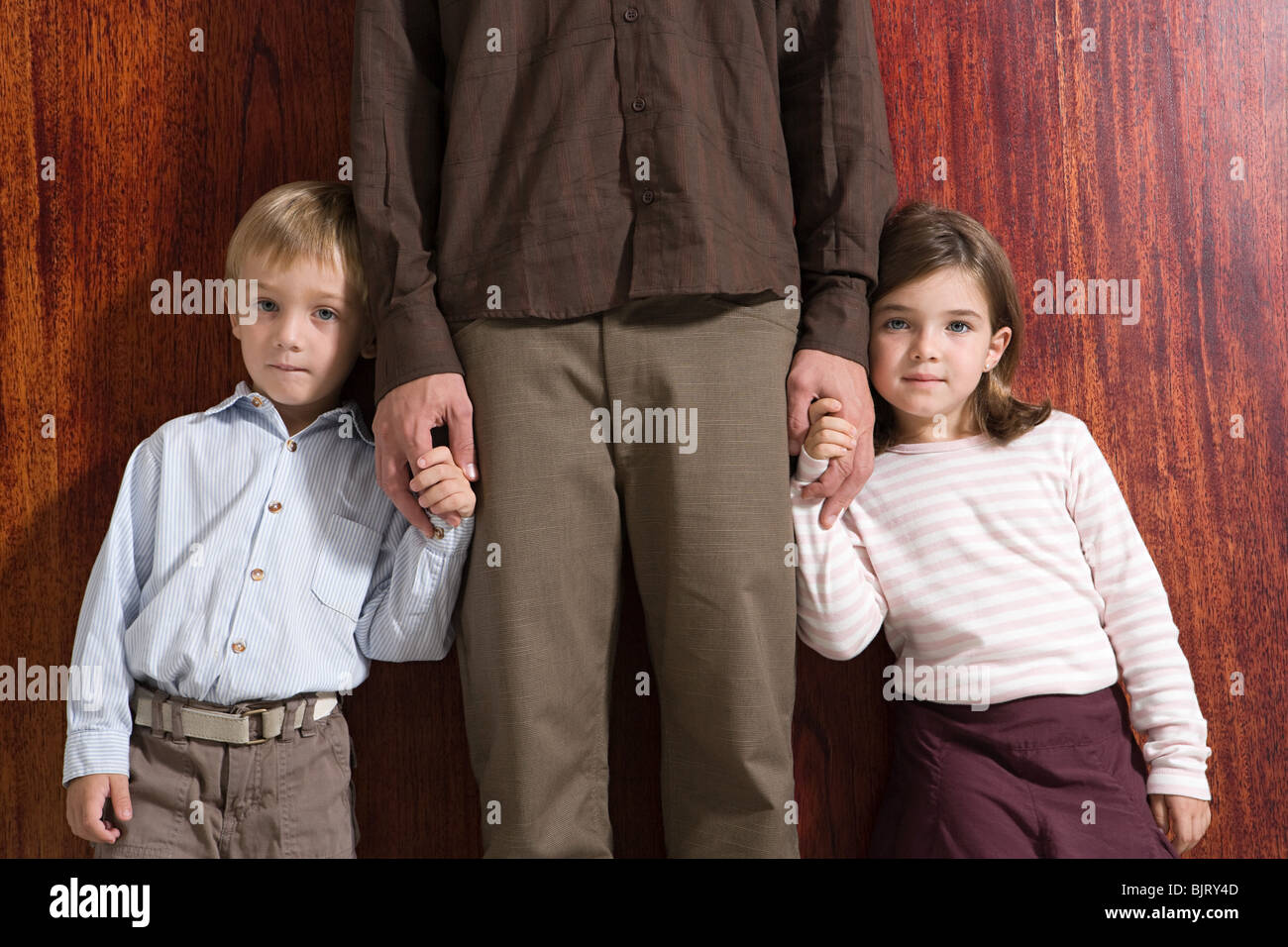 Children holding their fathers hand Stock Photo - Alamy