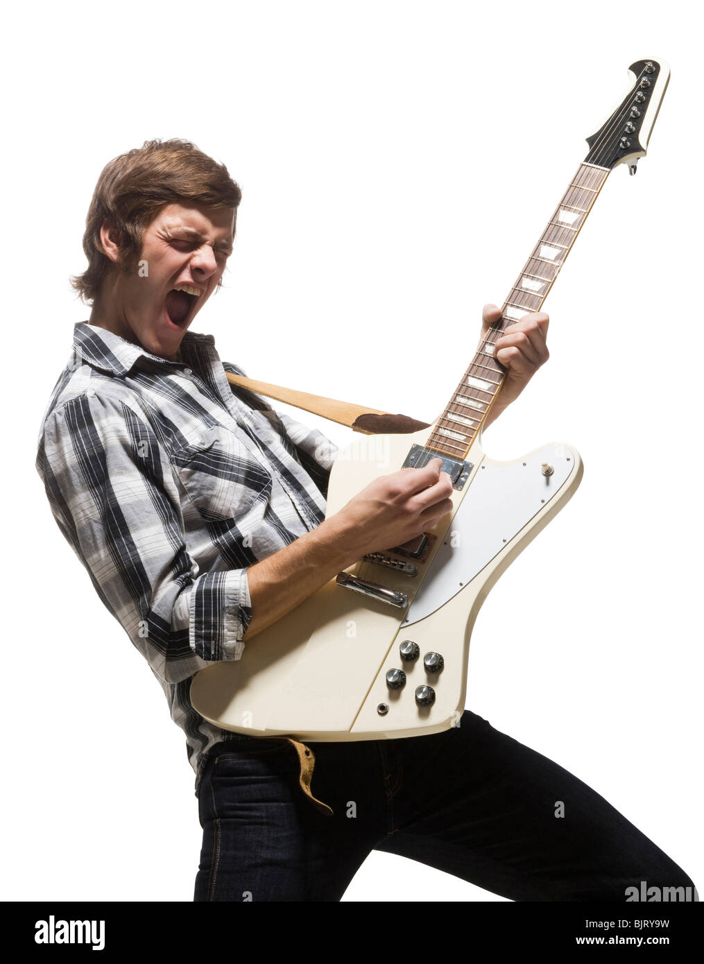 Young man playing electric guitar, shouting Stock Photo - Alamy