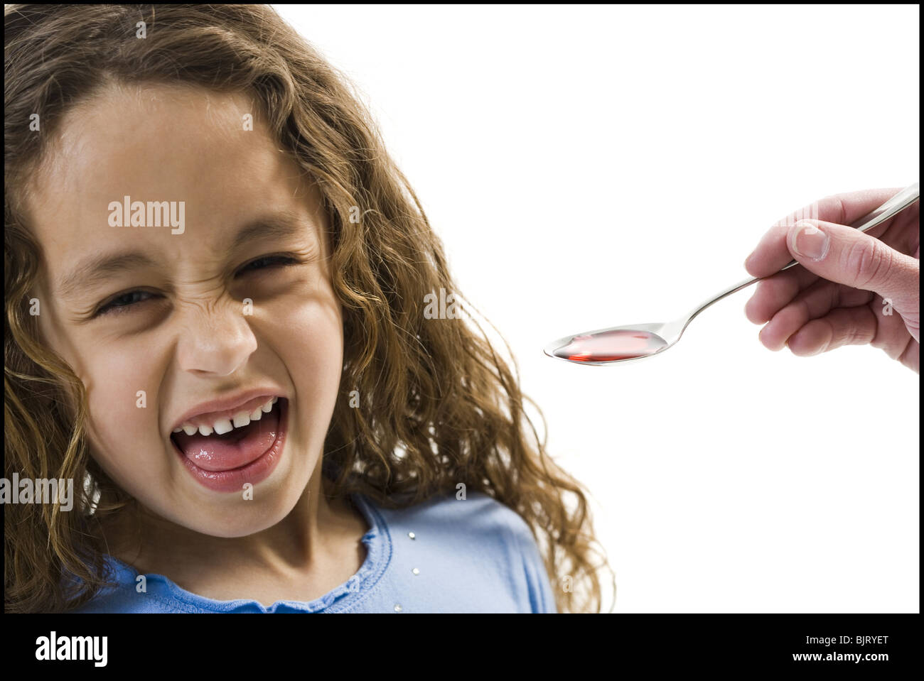 Young girl taking a spoonful of medicine Stock Photo - Alamy