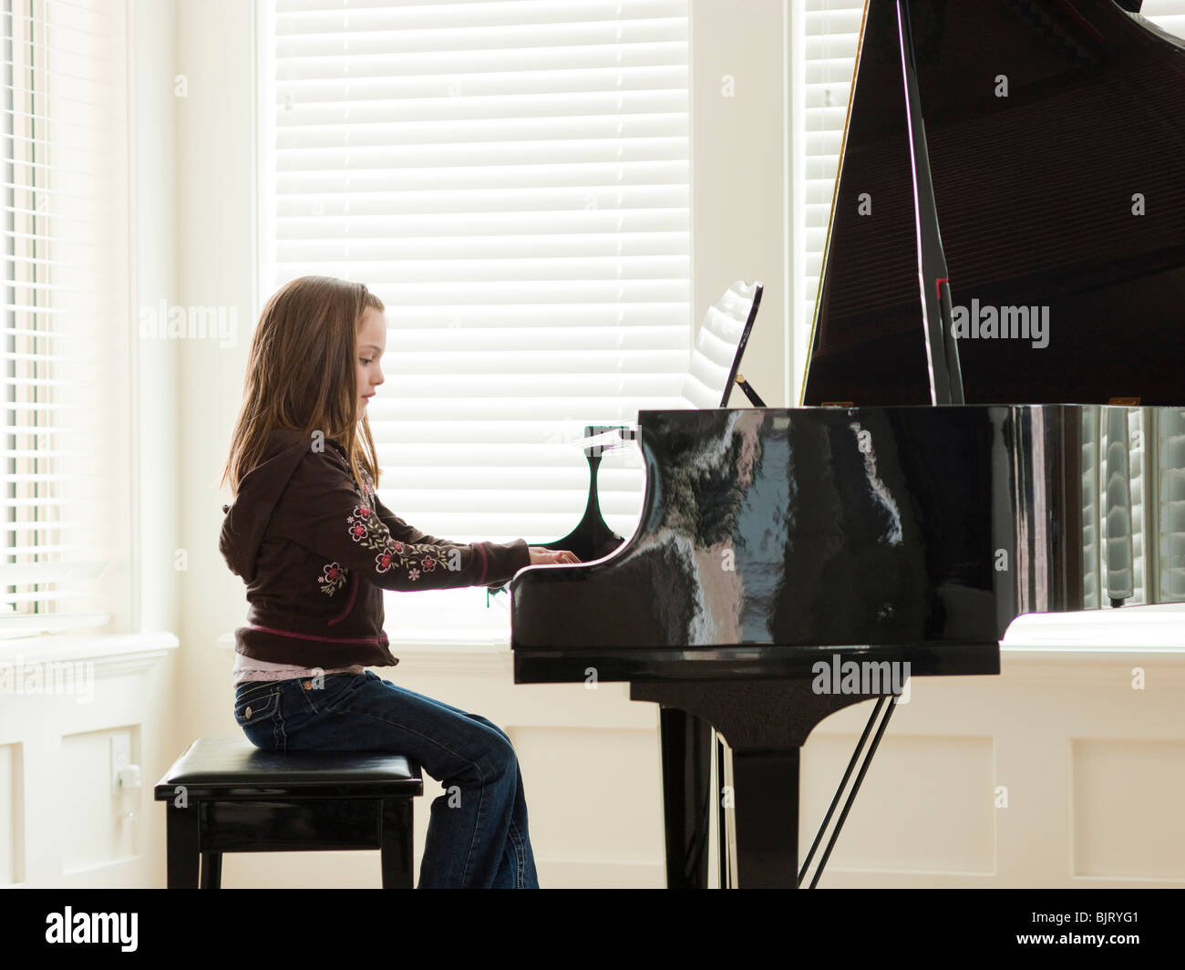 USA, Utah, Alpine, girl (8-9) practicing piano, side view Stock Photo ...
