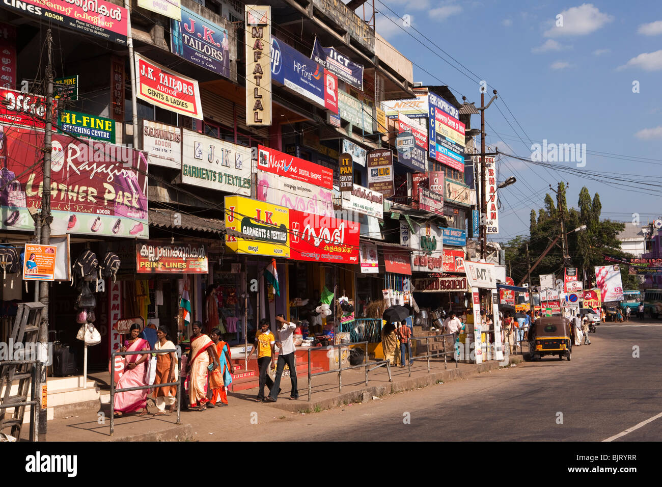 India, Kerala, Adoor, confusing mass of colourful signs advertising ...