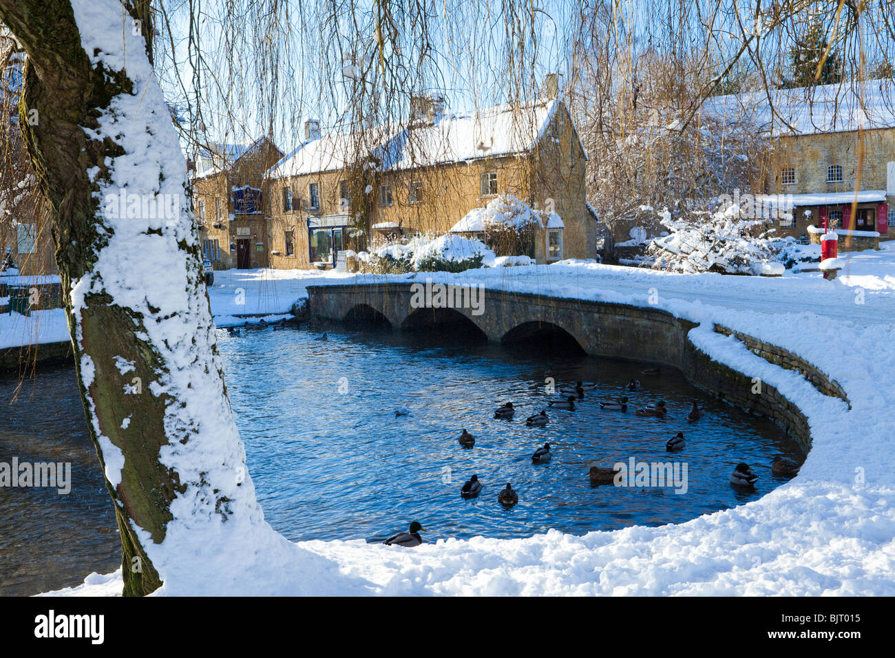Winter snow on one of the bridges over the River Windrush in the ...