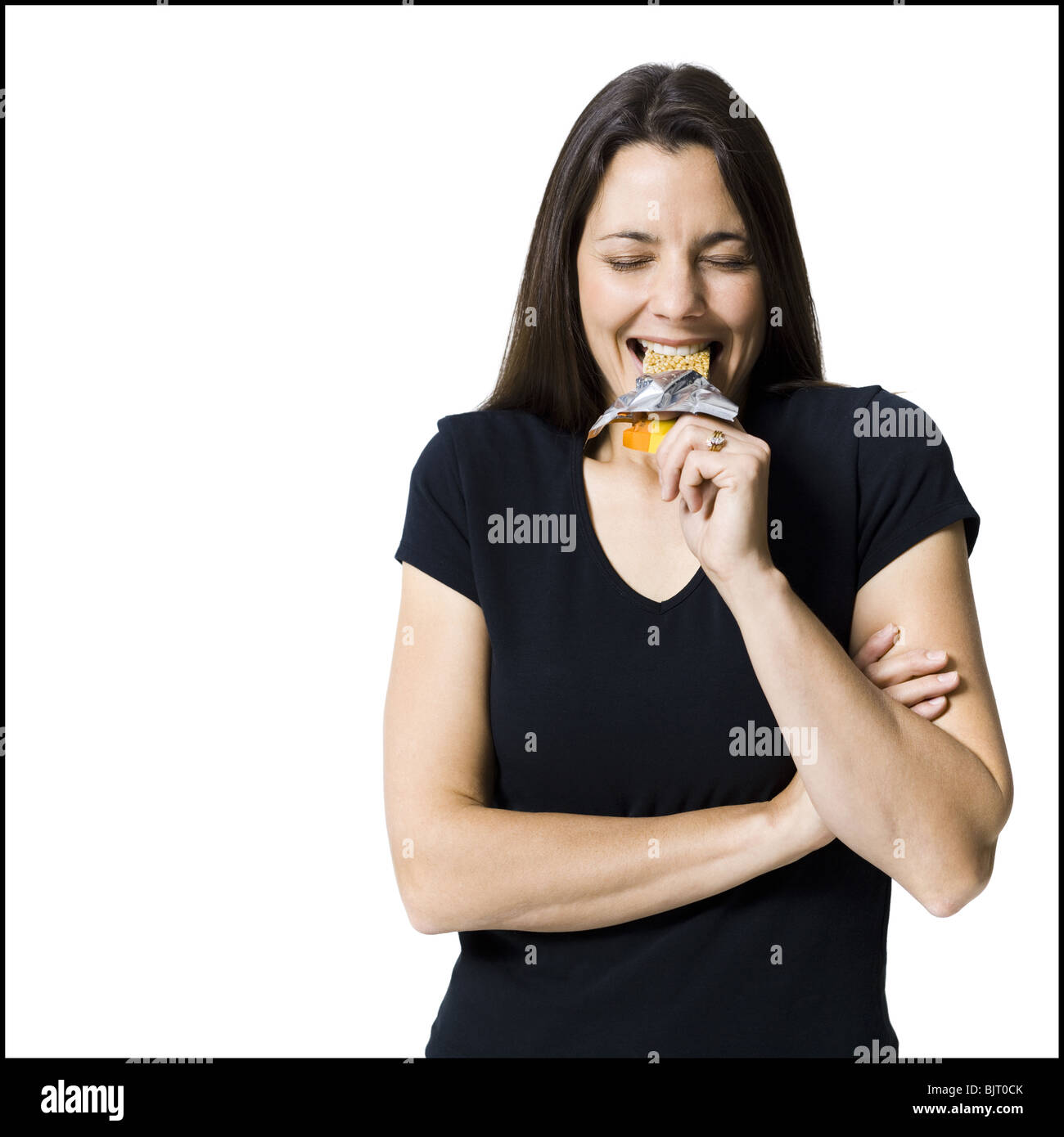 Woman eating a snack bar Stock Photo - Alamy