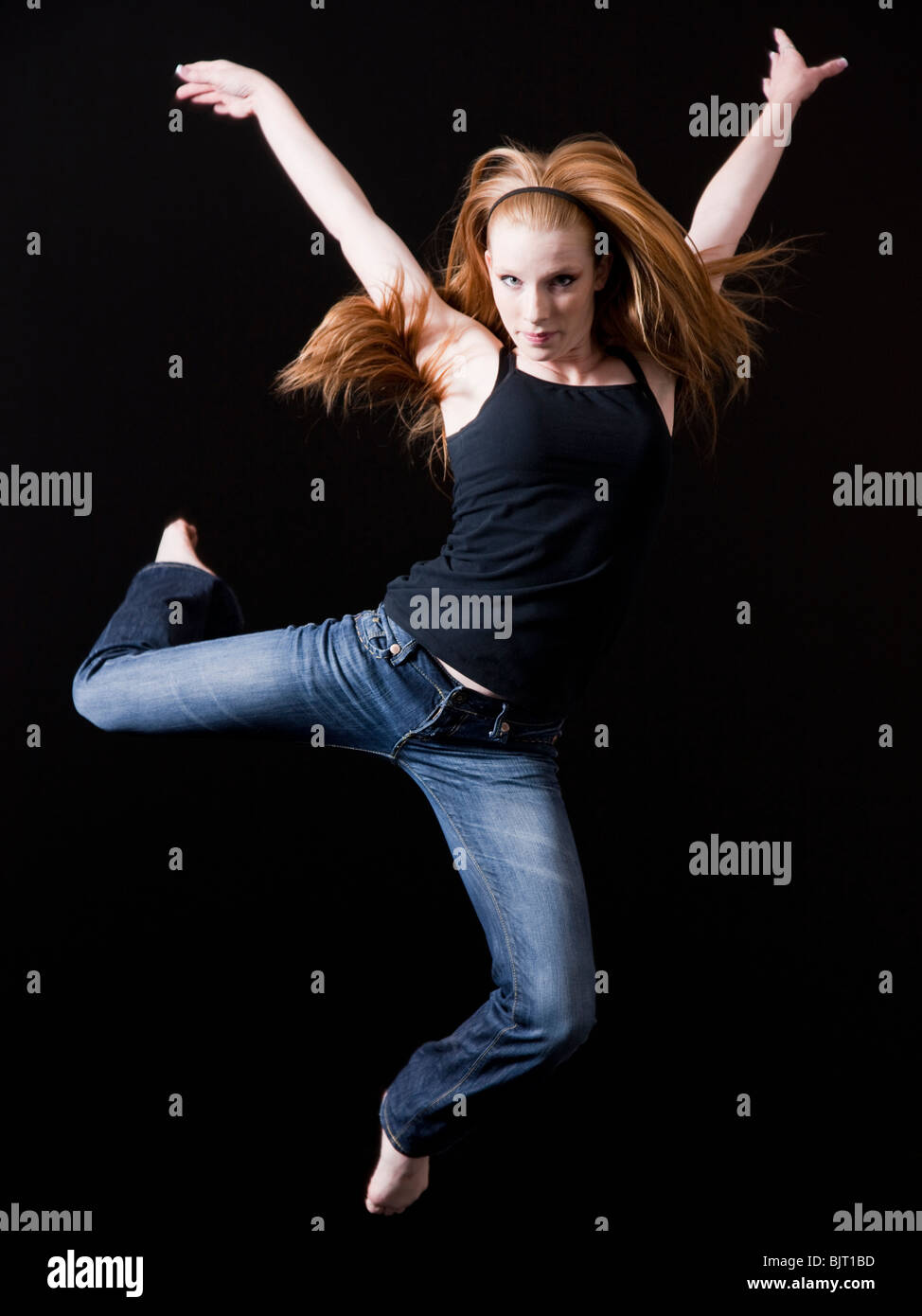 Young woman jumping, studio shot Stock Photo - Alamy