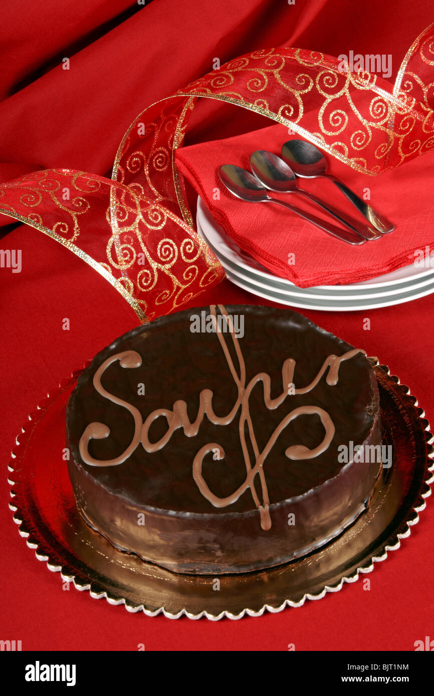 Famous austrian chocolate cake called sacher torte served on a golden ...