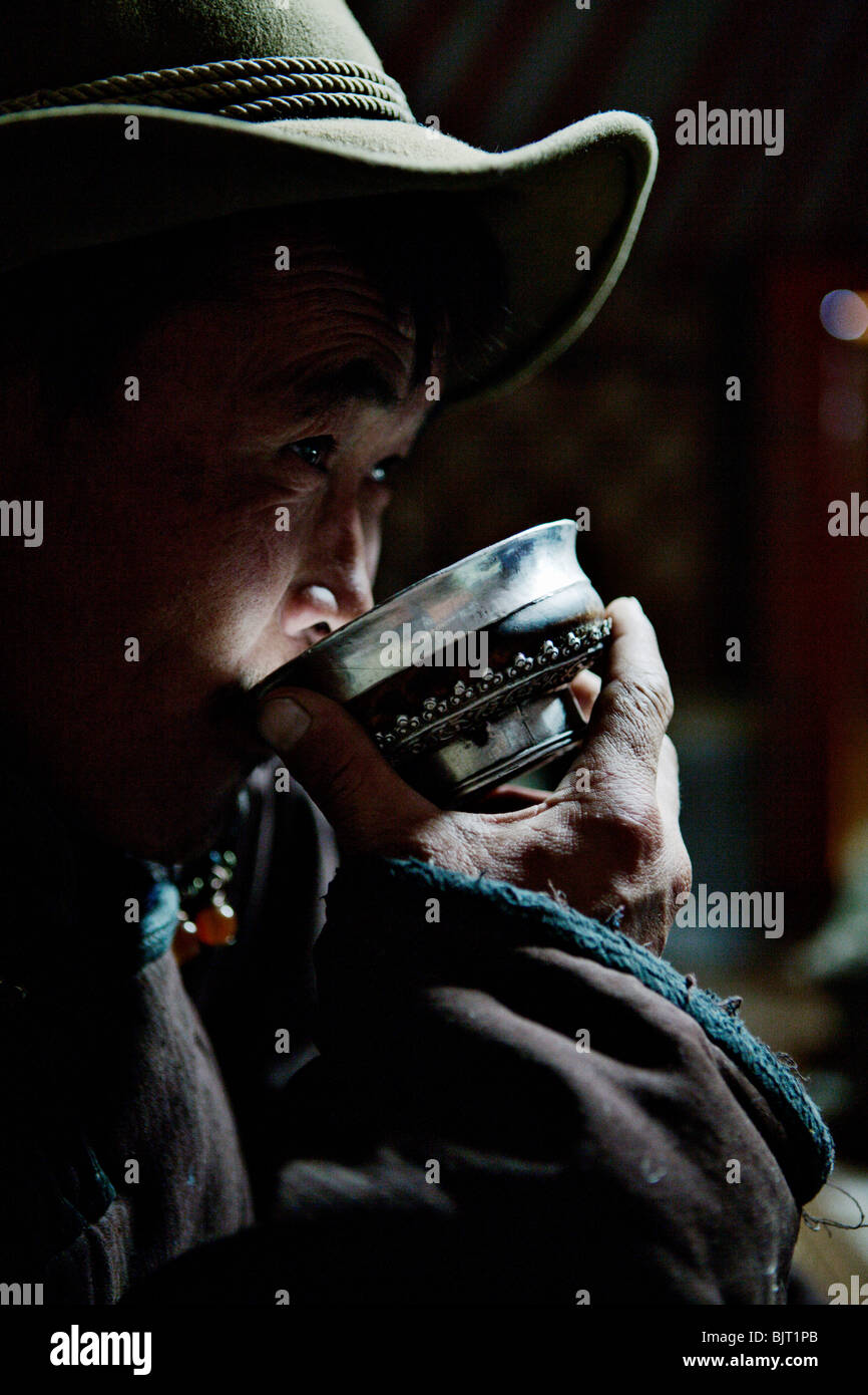 Man drinking arkhi, home-made alcohol distilled from milk, in Gobi ...