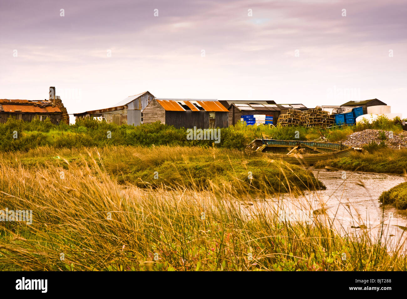 old fishing huts and wreck on the marshes at Brancaster Staithe ...