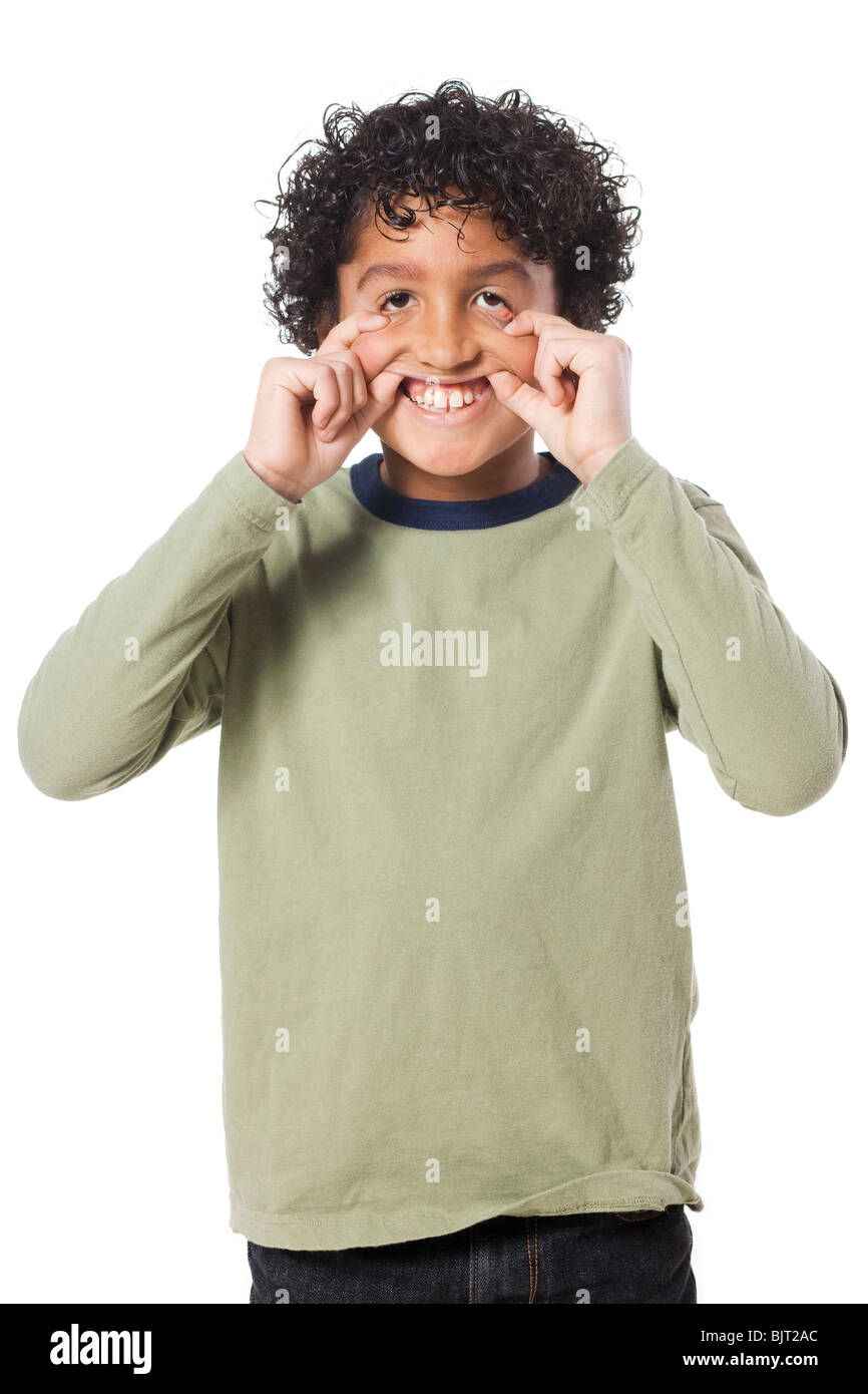 Studio portrait of boy (8-9) pulling funny face Stock Photo - Alamy