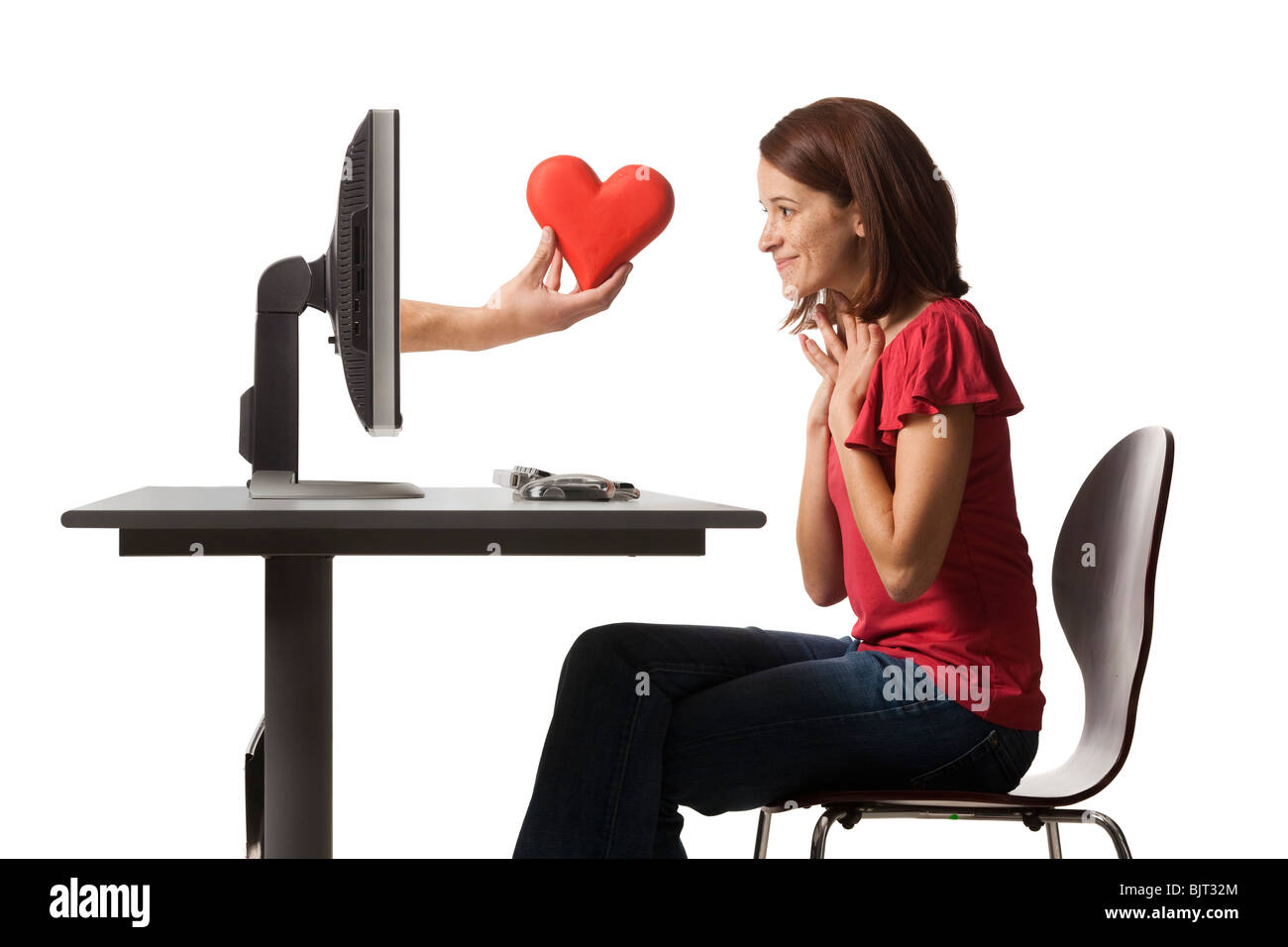 Conceptual picture of young woman receiving red heart out of her ...