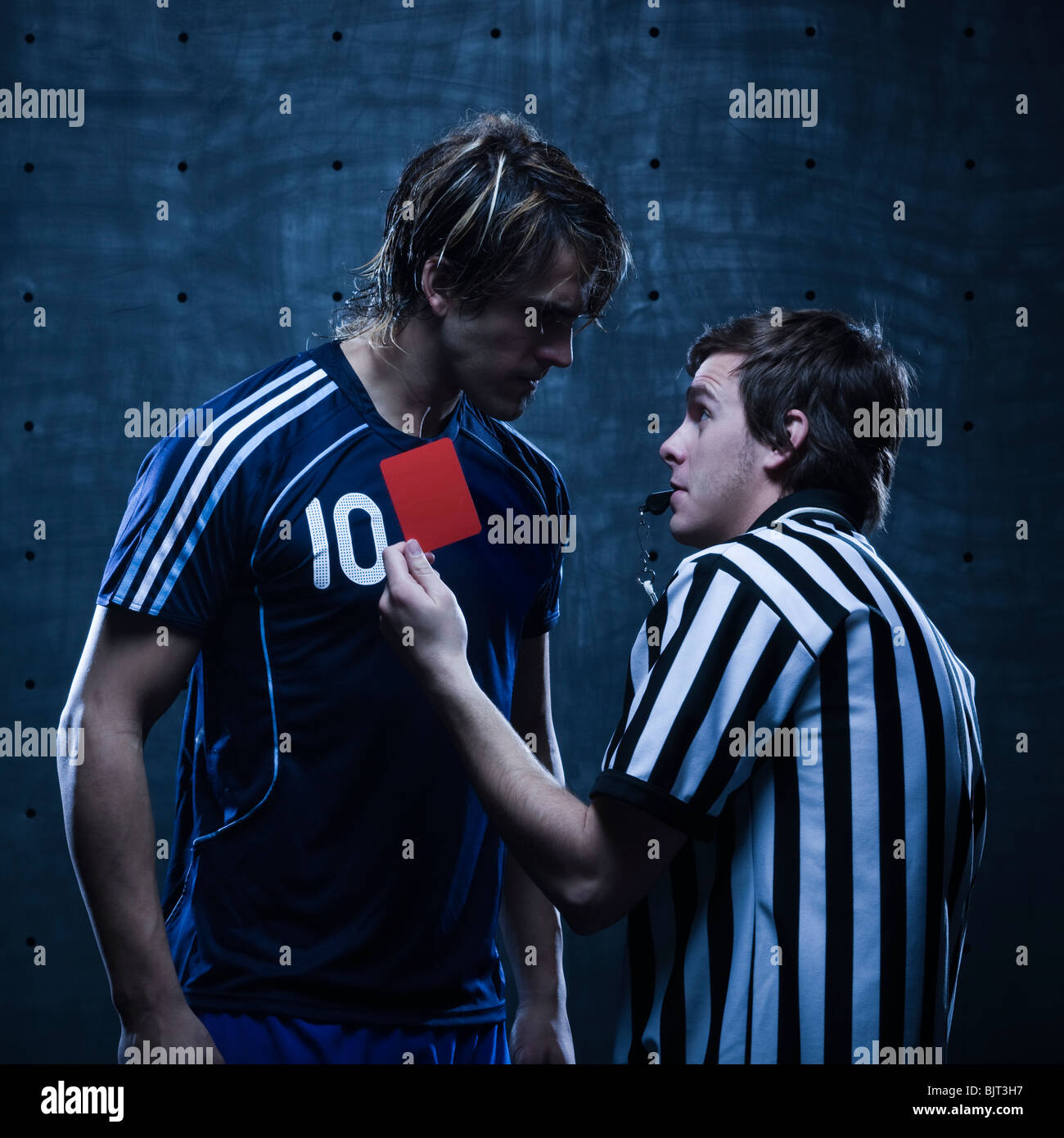 Studio shot of referee showing red card Stock Photo - Alamy