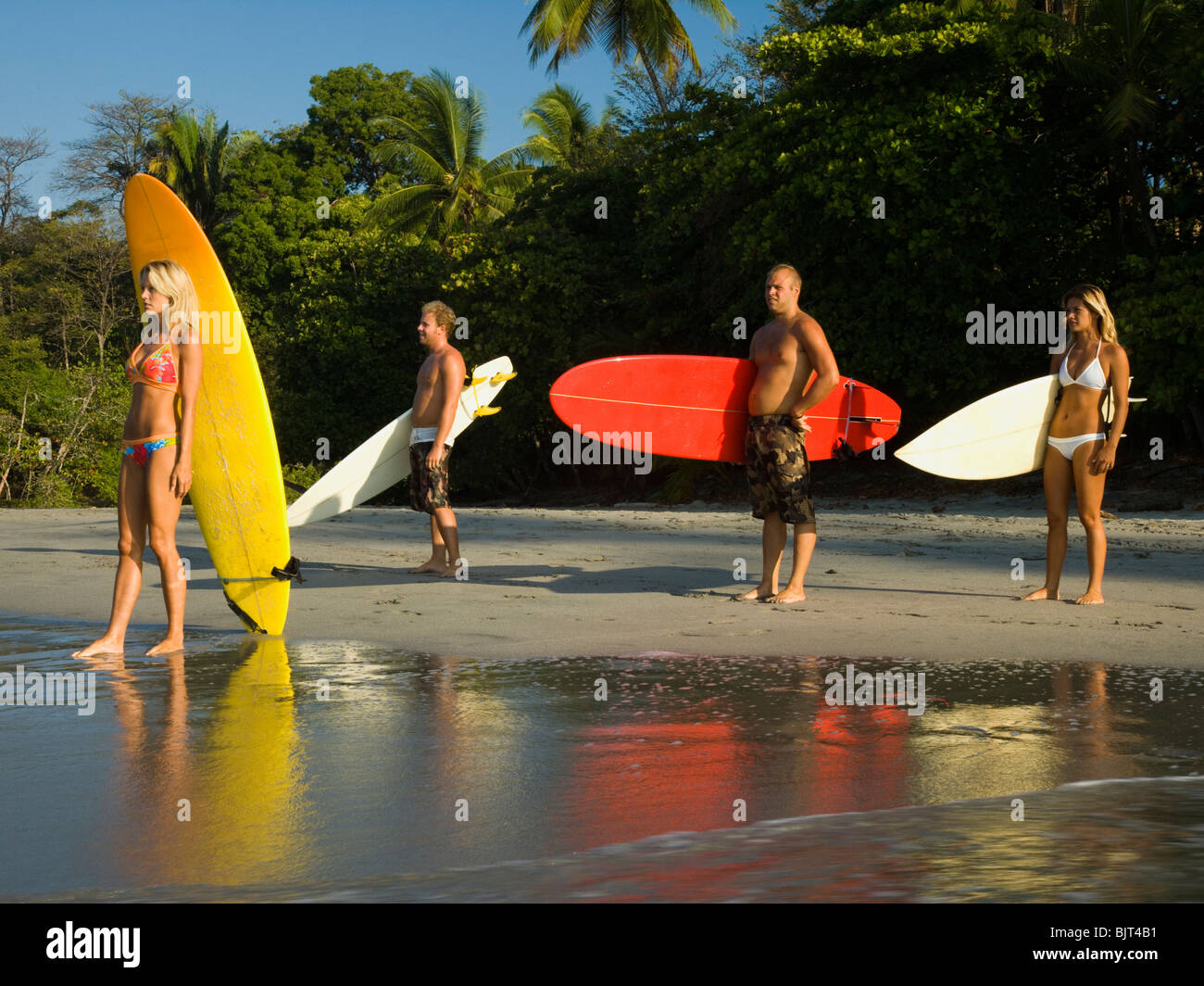 Male and female surfers Stock Photo - Alamy