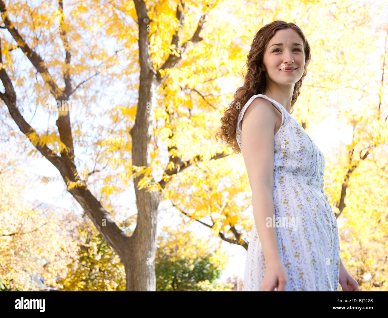 Provo, USA, Utah, Young woman in front of colorful tree, portrait Stock ...