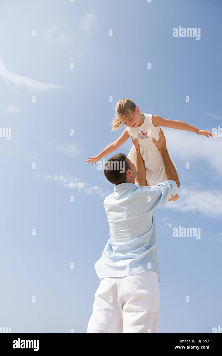 Father lifting daughter Stock Photo - Alamy