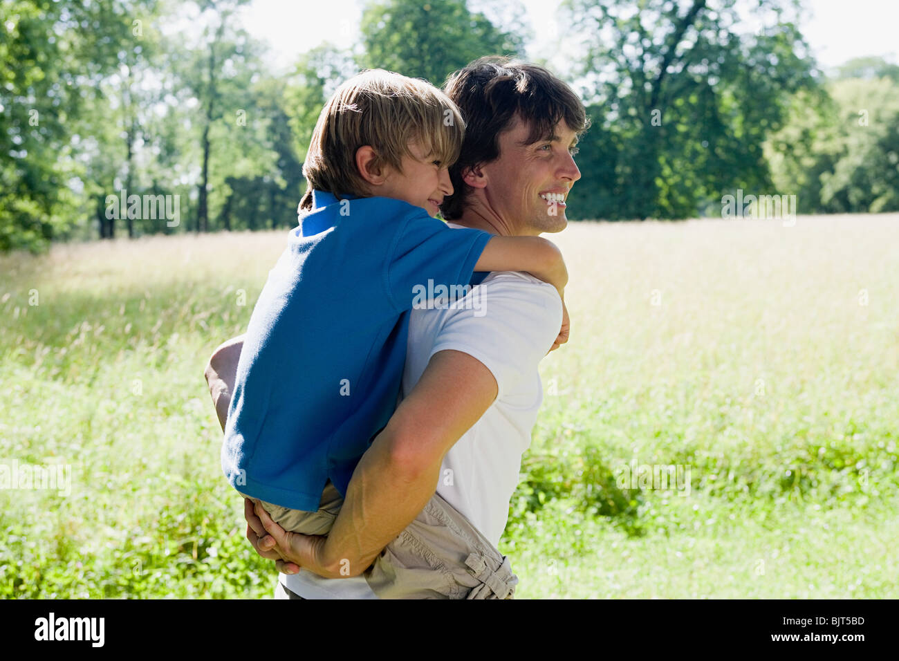 Father giving son a piggyback Stock Photo - Alamy