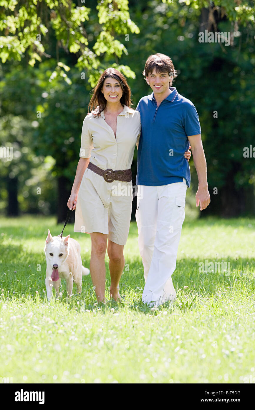 Couple walking with their dog hi-res stock photography and images - Alamy